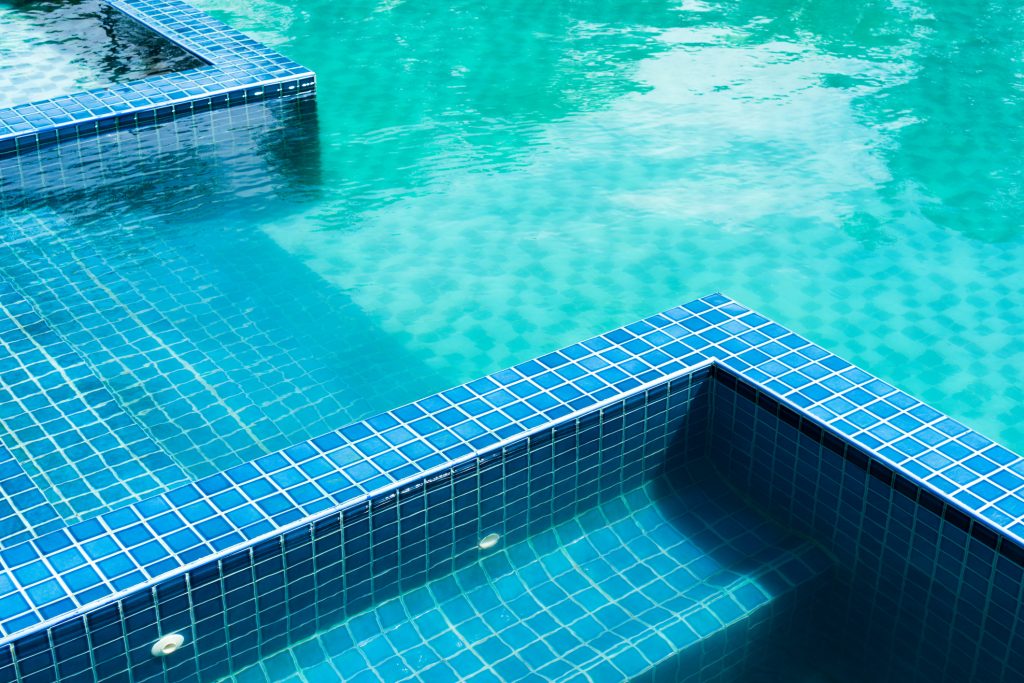 Blue mosaic tile steps in green swimming pool – Creative Tile ...